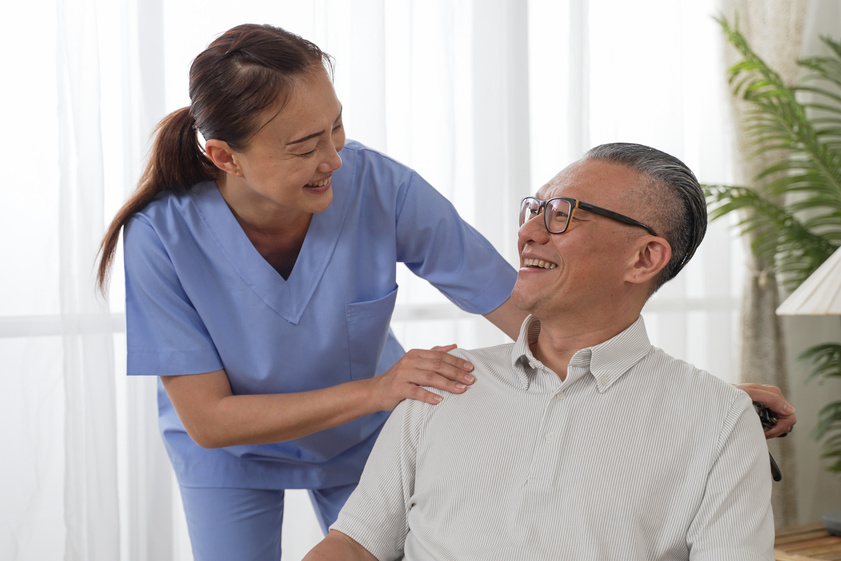 nursing aide talking and encouraging older male | Morada Senior Living