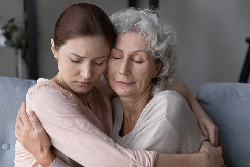Caring millennial woman child embrace unhappy upset old 60s mother show ...